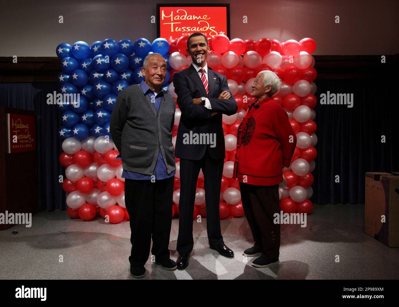 Mainland Chinese tourists poses at the newly unveiled wax figure of U.S ...