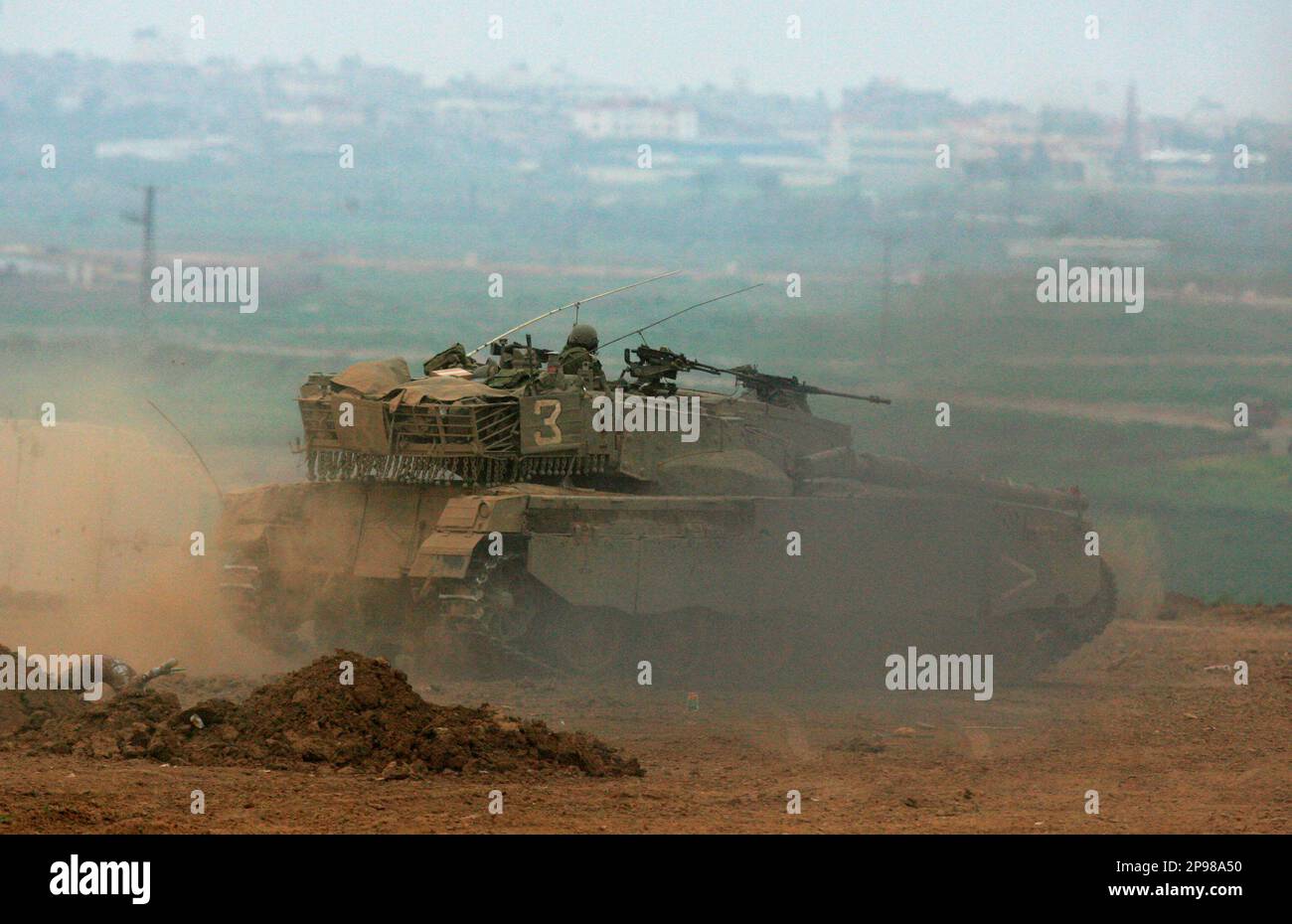 An Israeli army tank patrols near the Israeli Gaza border, Tuesday, Jan ...