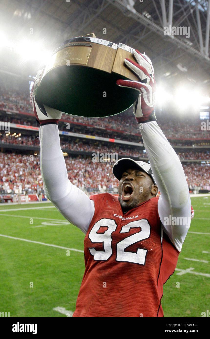 Arizona Cardinals defensive end Bertrand Berry holds the George Halas ...