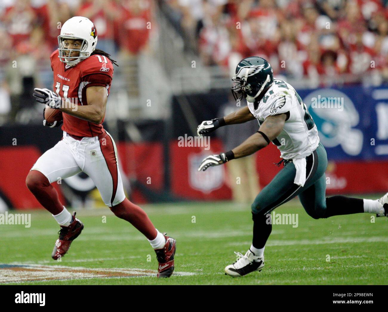 Arizona Cardinals wide receiver Larry Fitzgerald is pursued by ...