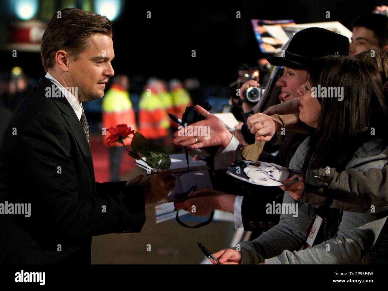 U.S. actor Leonardo DiCaprio signs autographs for fans as he arrives on ...