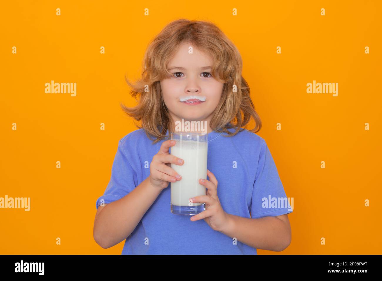 Healthy drink with calcium and protein for kids. Small boy drink a ...