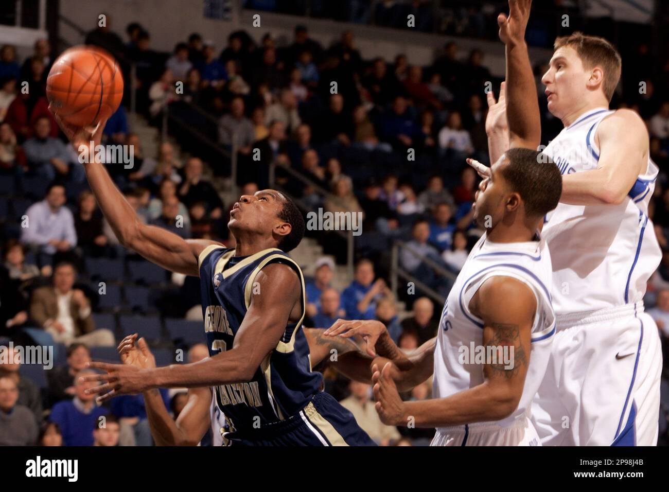 George Washington's Tony Taylor, left, heads to the basket as Saint ...