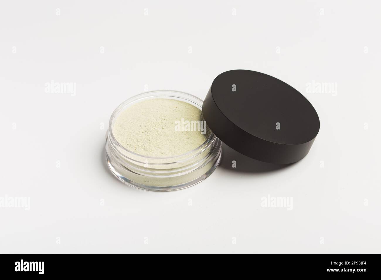 Green cosmetic mineral powder for face - top view isolated on white ...