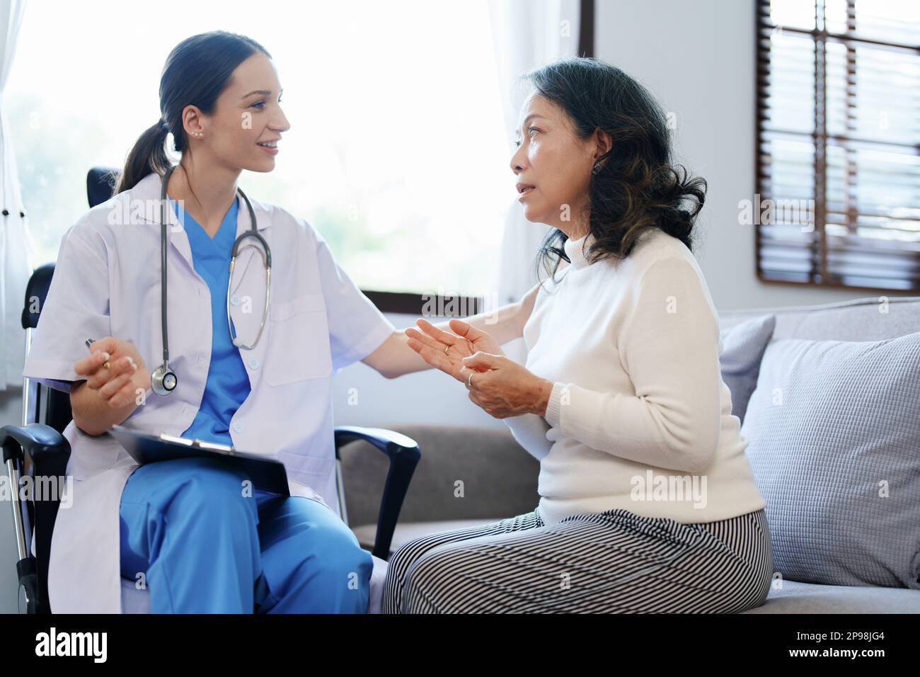 Portrait of a female doctor holding clipboard documents to discuss and ...