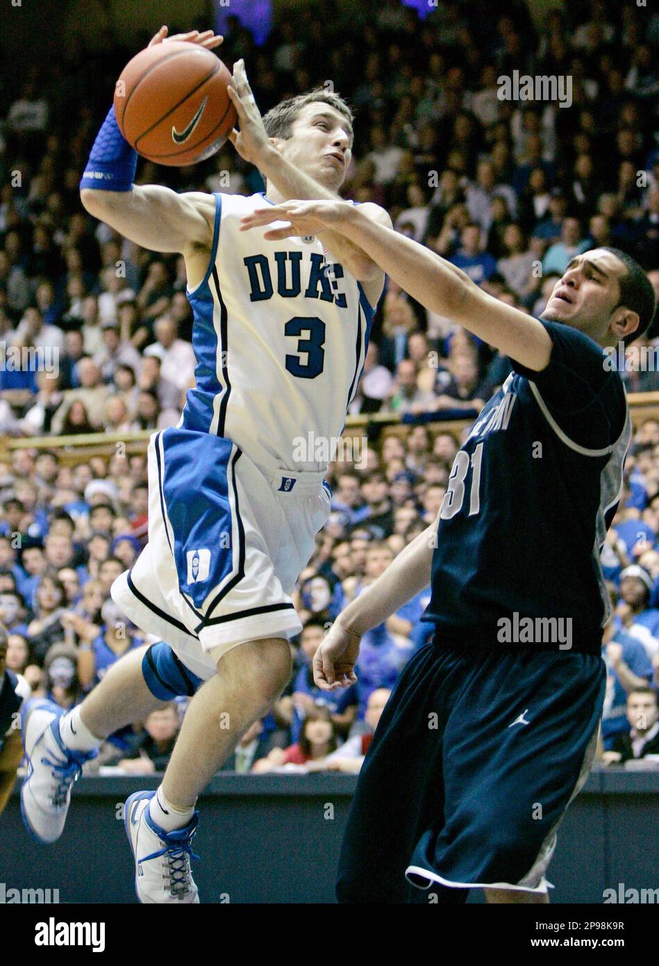 Duke's Greg Paulus (3) drives to the basket as Georgetown's Omar Wattad ...