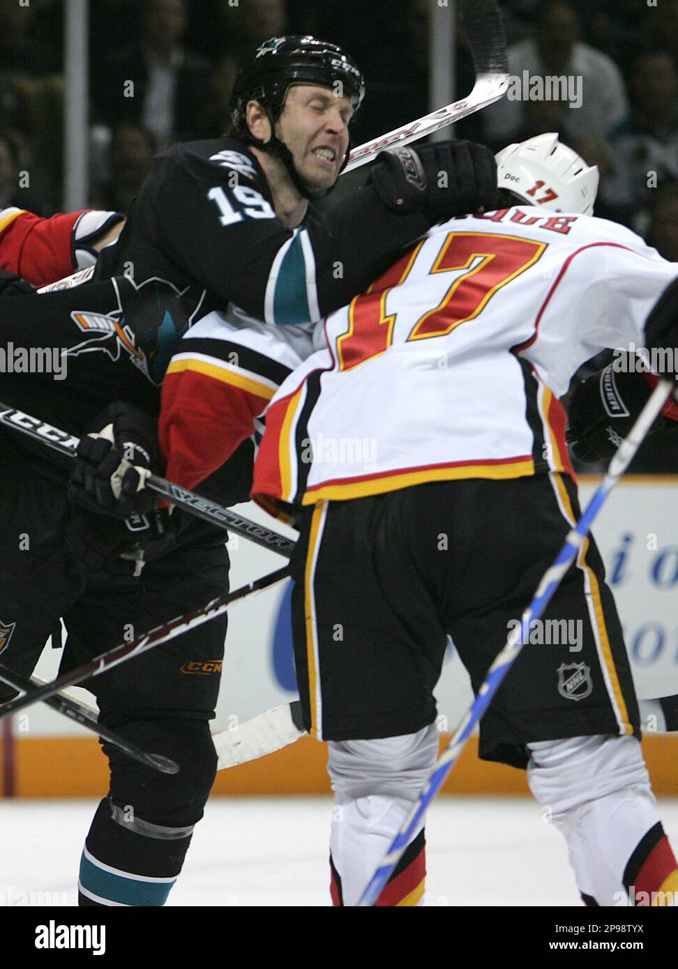 San Jose Sharks center Joe Thornton, left, fights with Calgary Flames ...