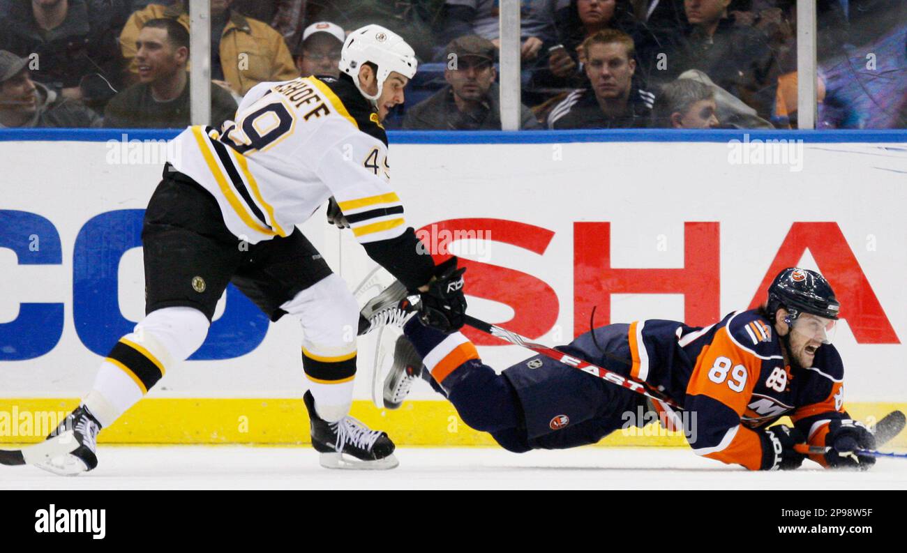 New York Islanders' Mike Comrie, right, trips while battling for the ...