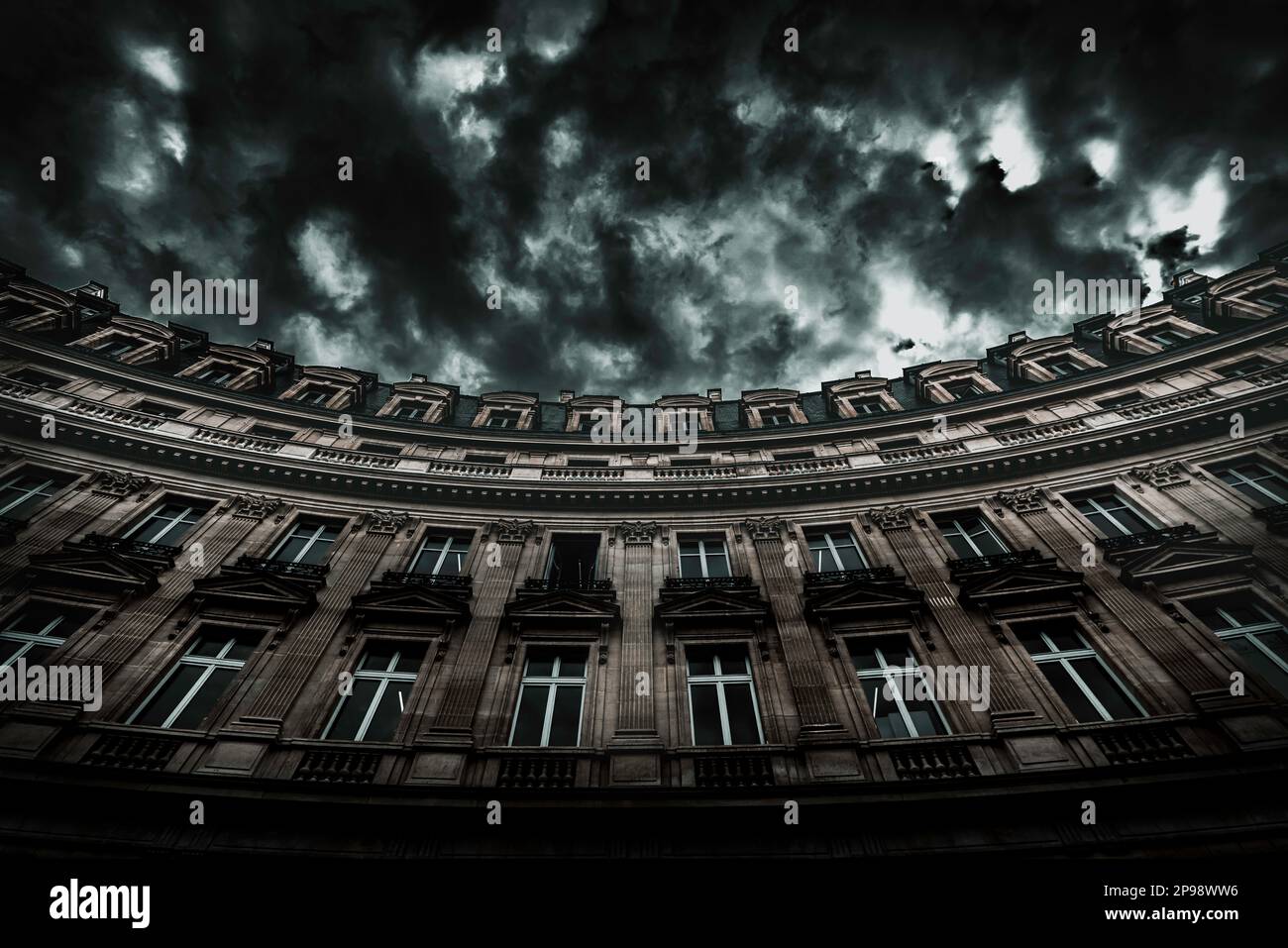 A building standing with a backdrop of ominous clouds gathering in the ...