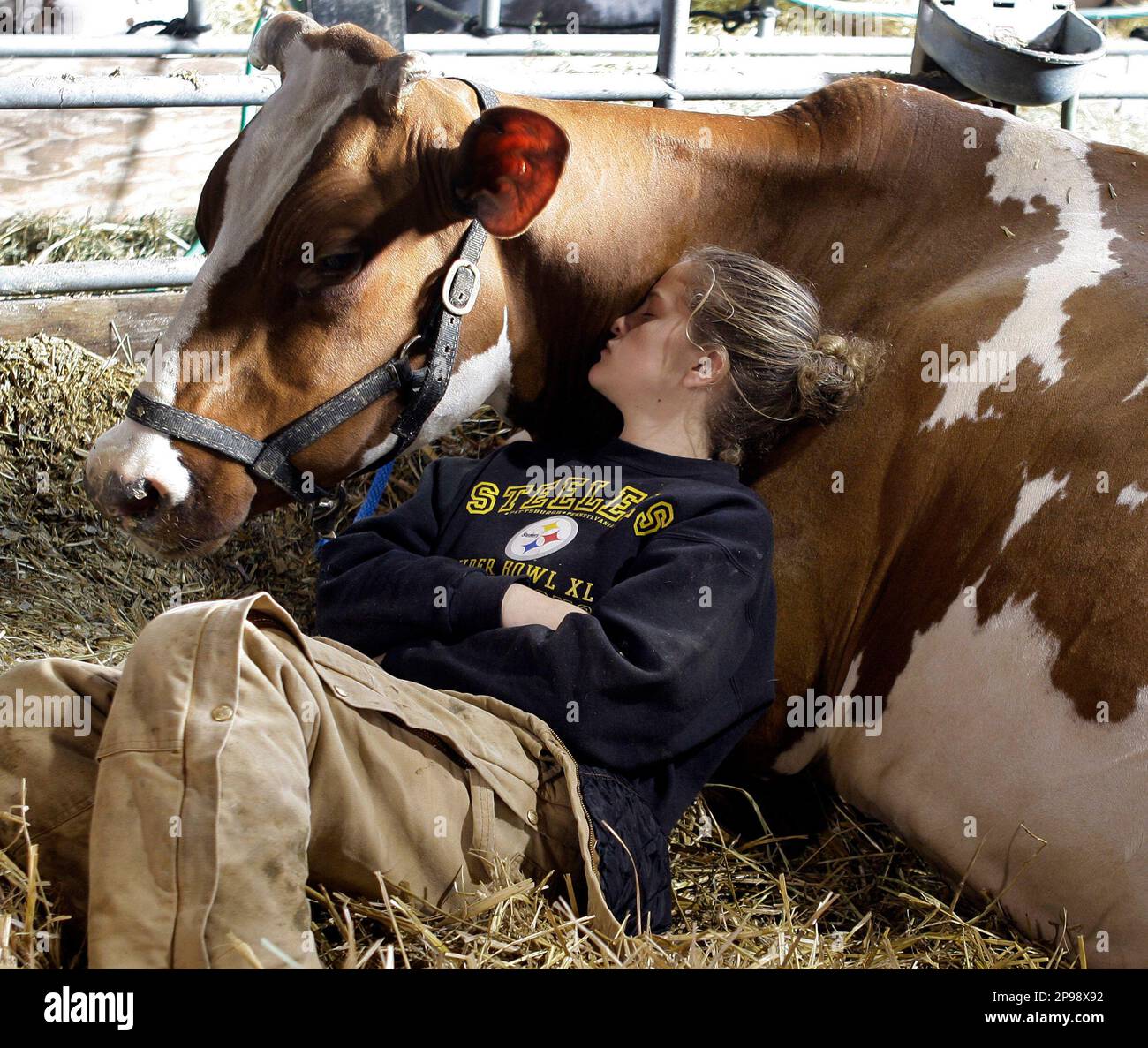 Stephanie Stall of Rockwood, Pa., curls up for a warm nap with Breeze ...