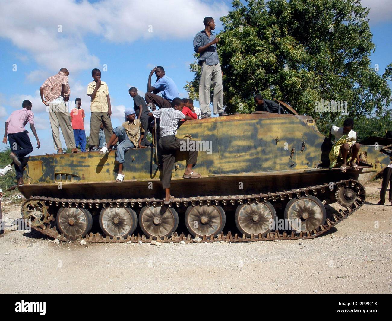 Somalis gather around a tank left by Ethiopian troops formerly based in ...