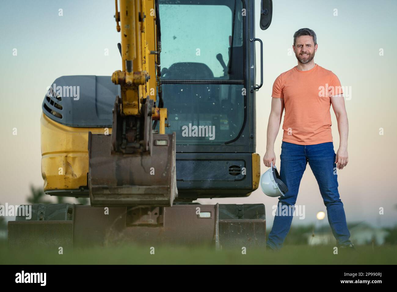Worker at construction site. Builder in hardhat. Construction man with ...