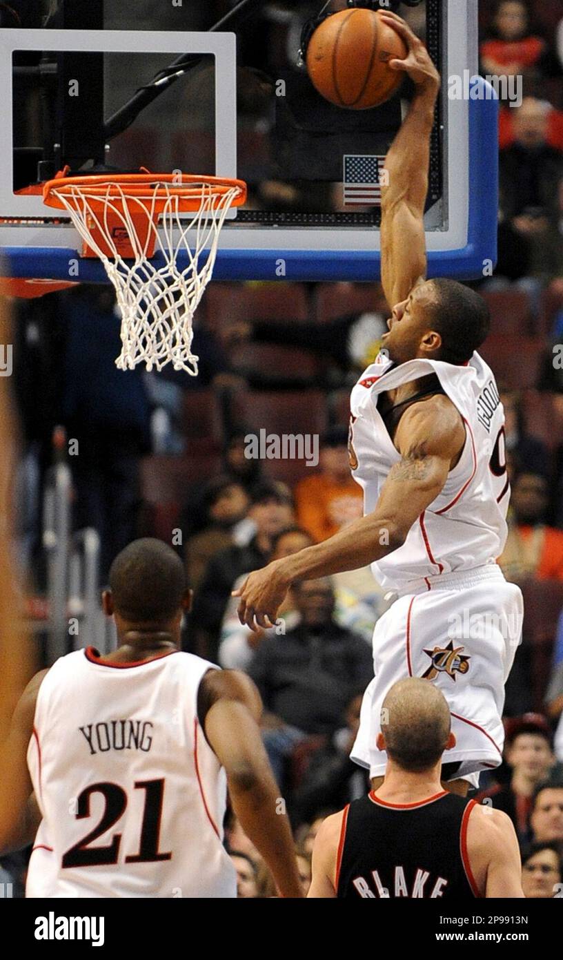 Philadelphia 76ers' Andre Iguodala, right, dunks over Portland Trail Blazers Steve Blake as ...