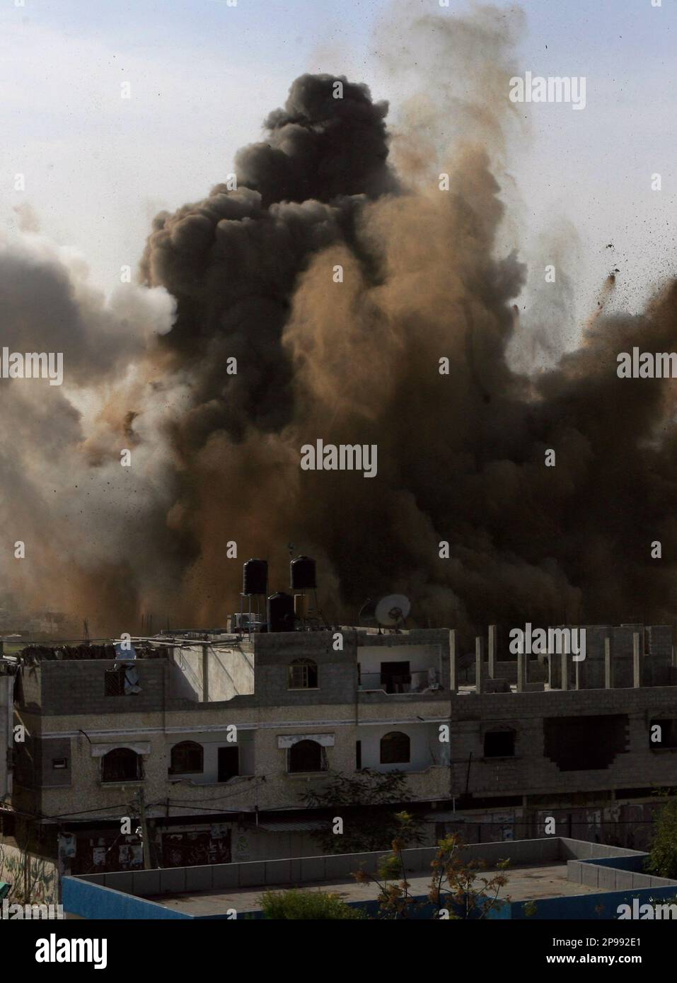 An explosion is seen where the Israeli military is bombing an area ...