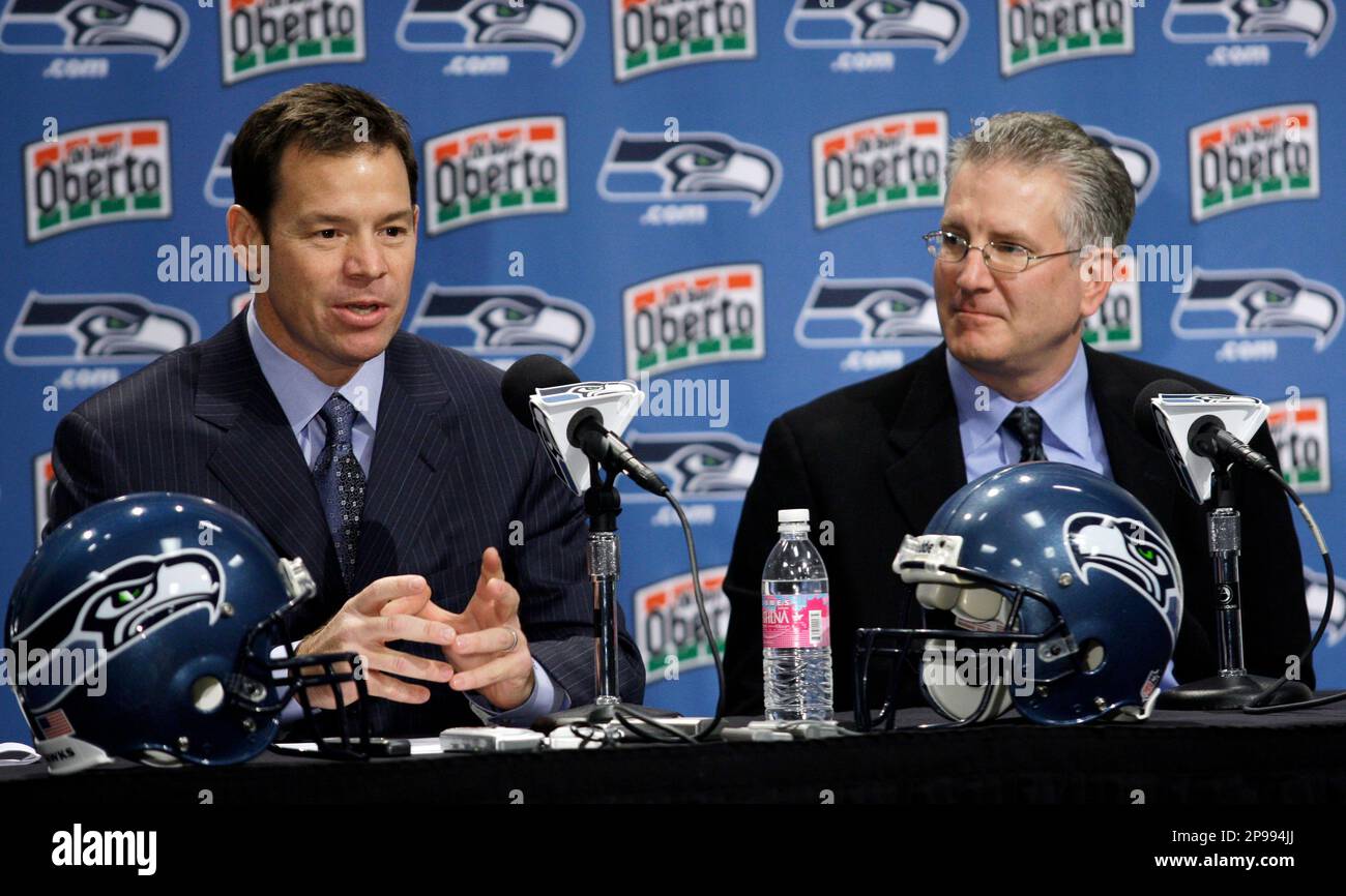 Seattle Seahawks head football coach Jim Mora, left, talks to reporters ...