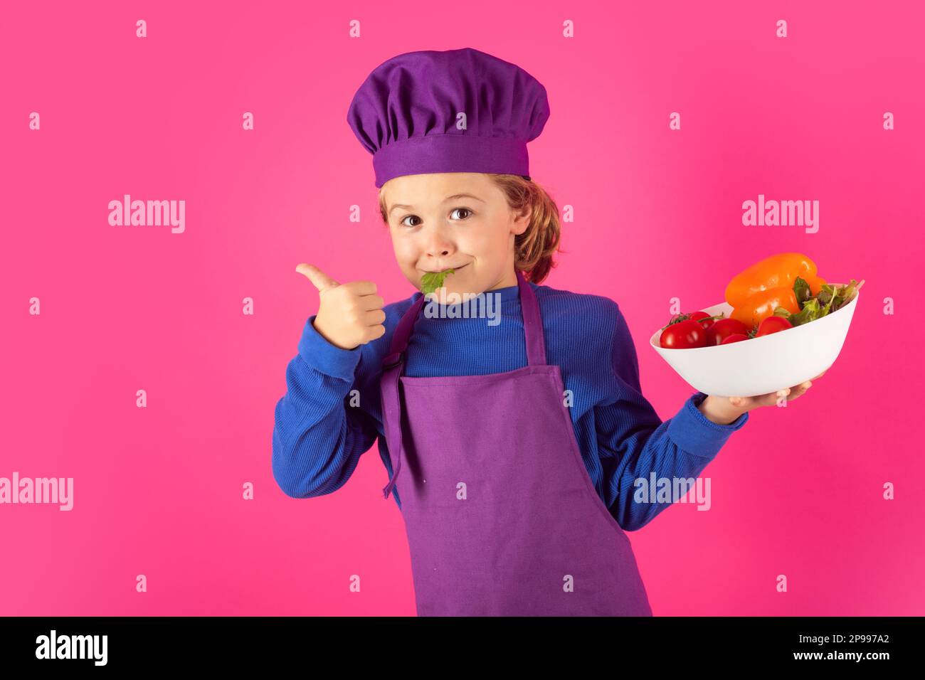 Child cook hold plate with vegetable. Cooking children. Chef kid boy in ...