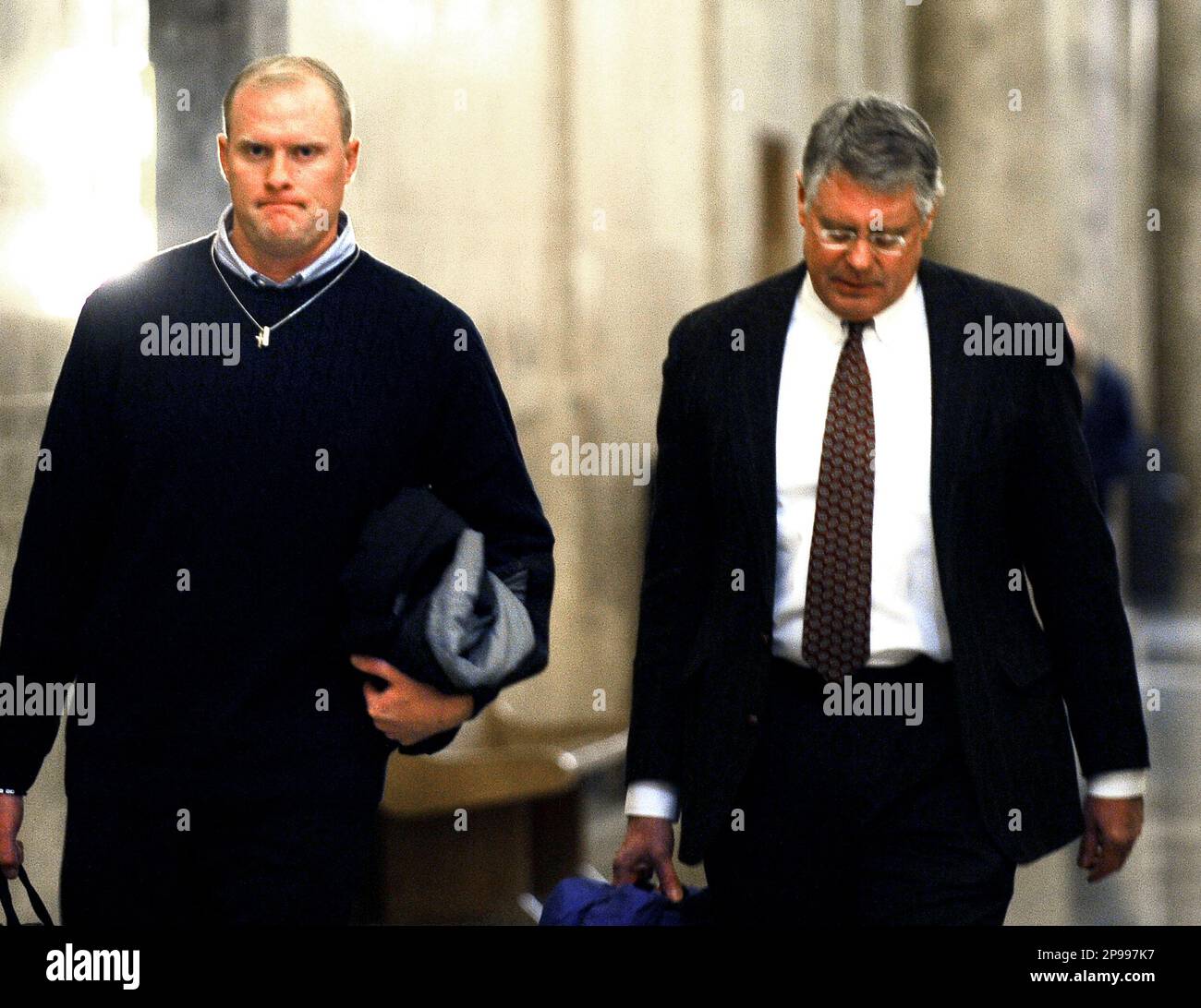 Alex Midyette, left, walks to the courtroom with his attorney Paul ...