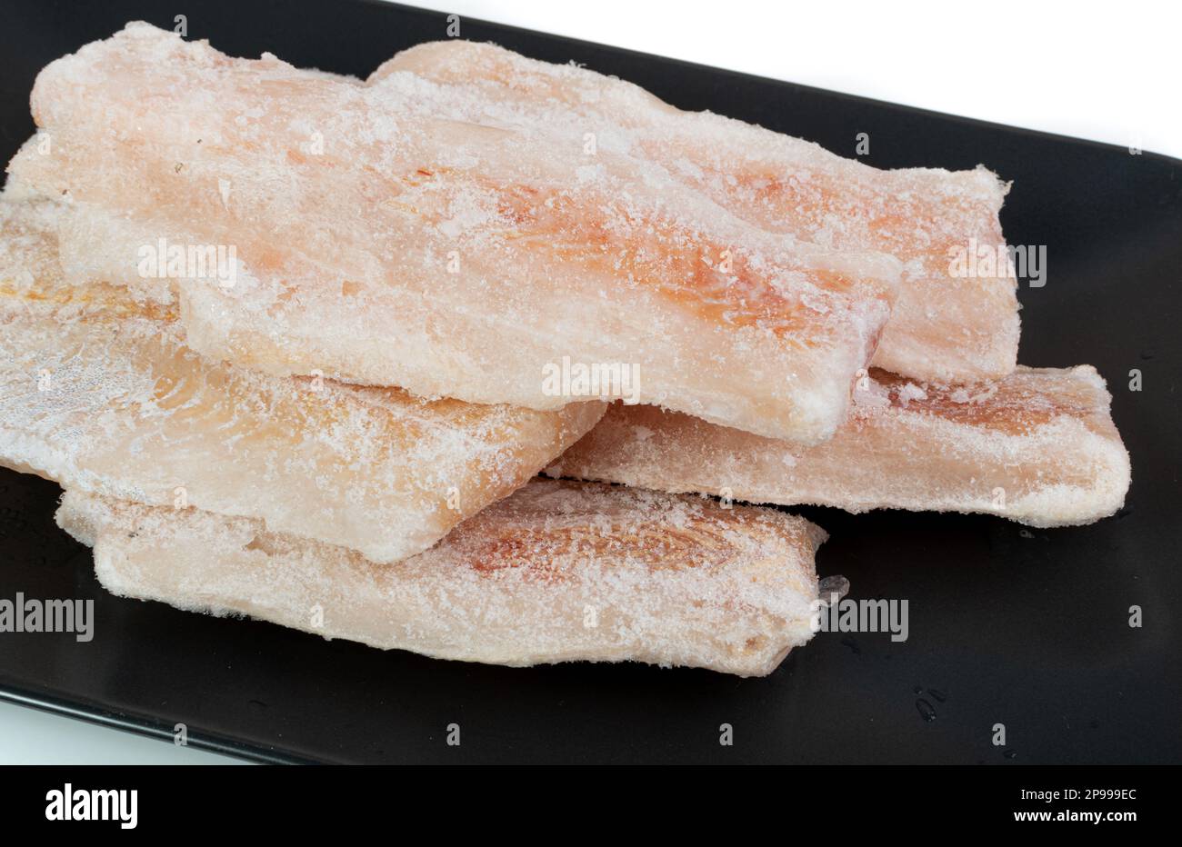 Frozen Fish on Black Plate, White Cod Fillet, Iced Hake Filet, Frozen ...