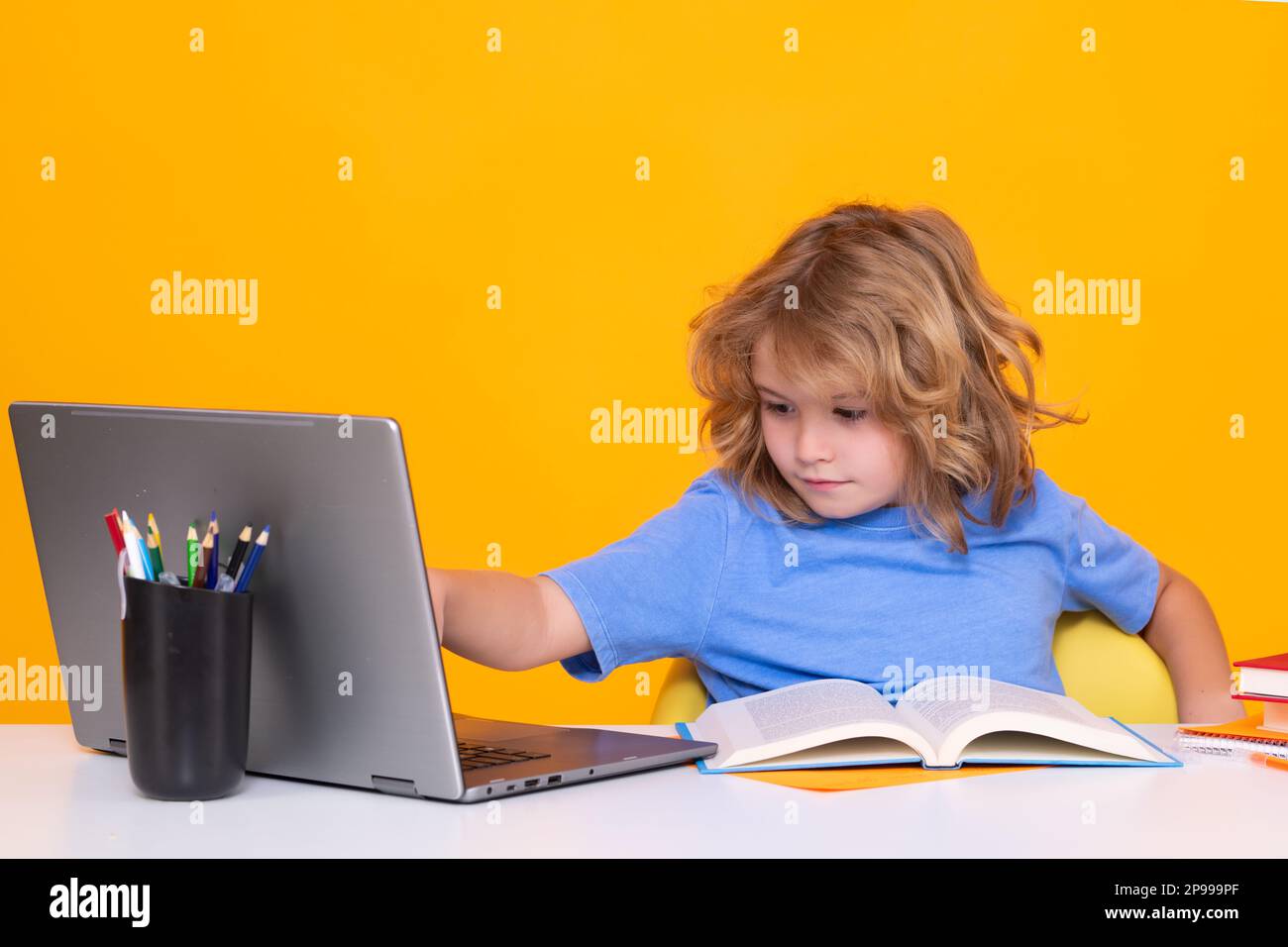 School child using laptop computer. School and kids. Cute blonde child ...
