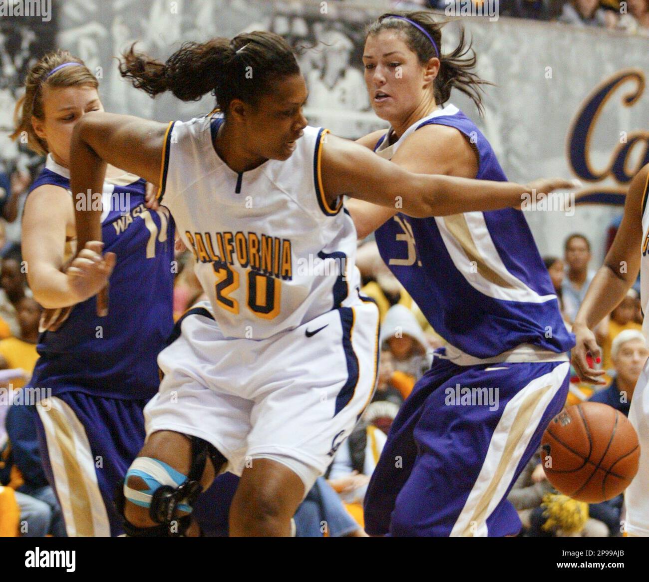 California's Devanei Hampton, center, loses the ball as Washington's ...