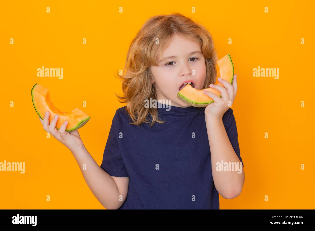 Child eat red melon in studio. Melon fruit. Studio portrait of cute kid ...