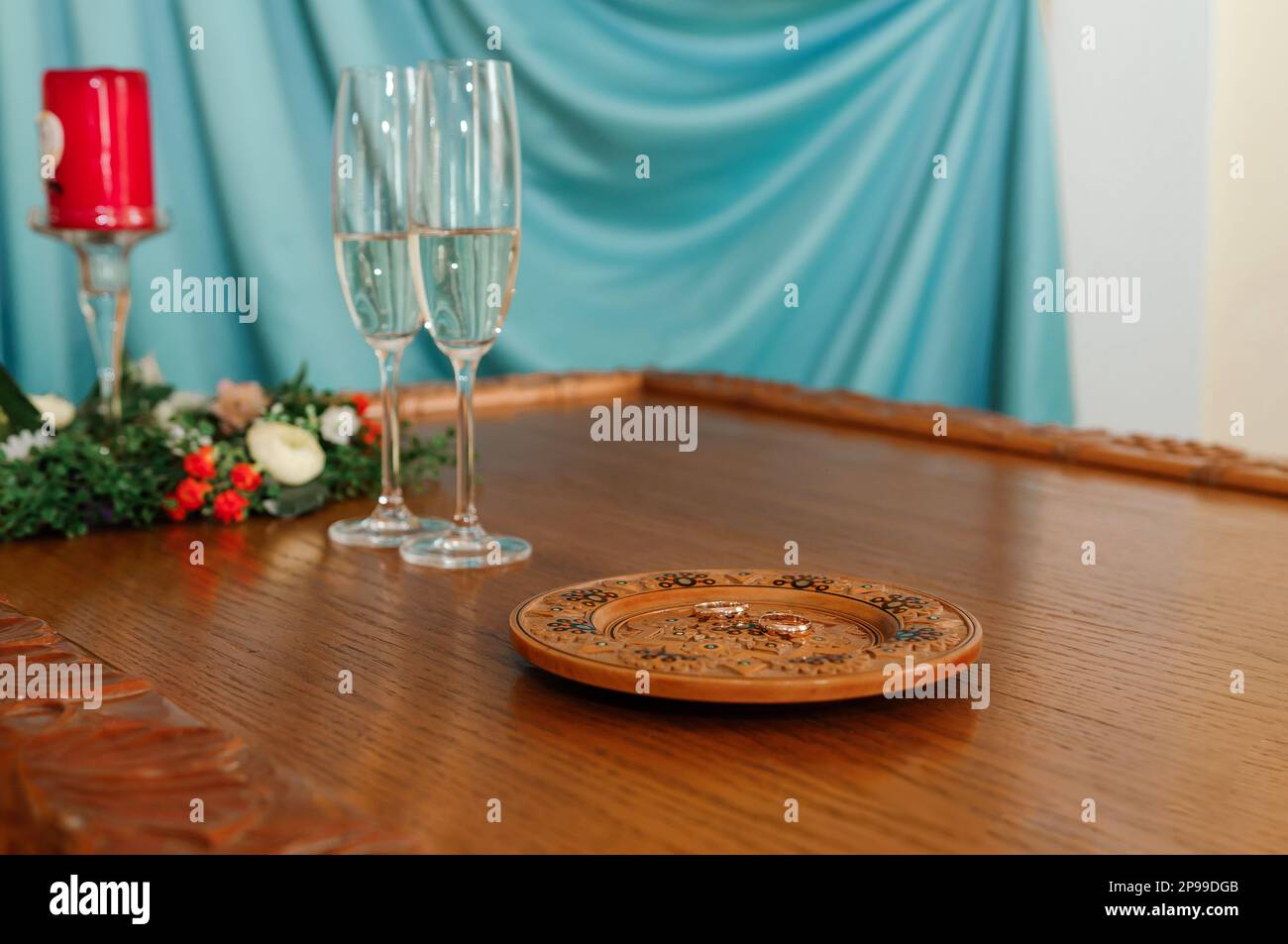 Golden wedding rings on a stand on the table Stock Photo - Alamy