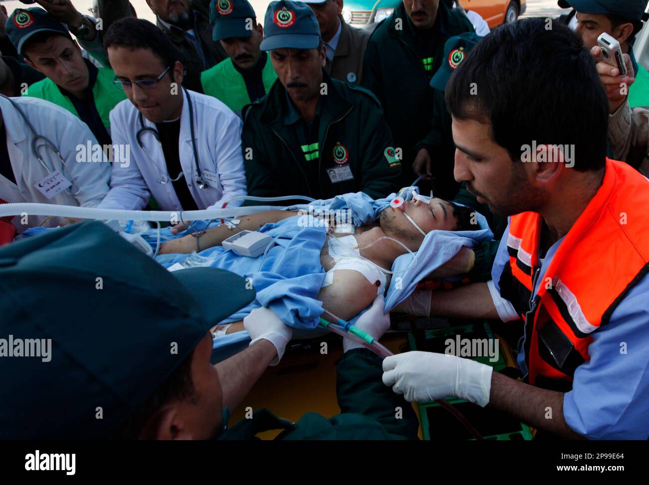 Paramedics move an injured Palestinian man out of a Palestinian ...