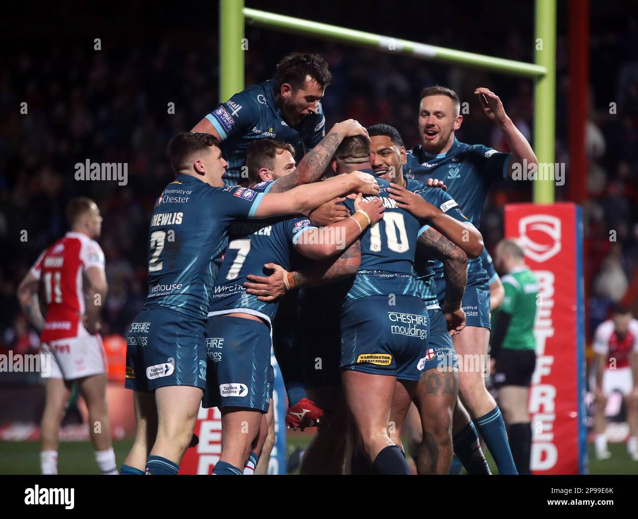Warrington Wolves' Paul Vaughan (centre) celebrates scoring their side ...