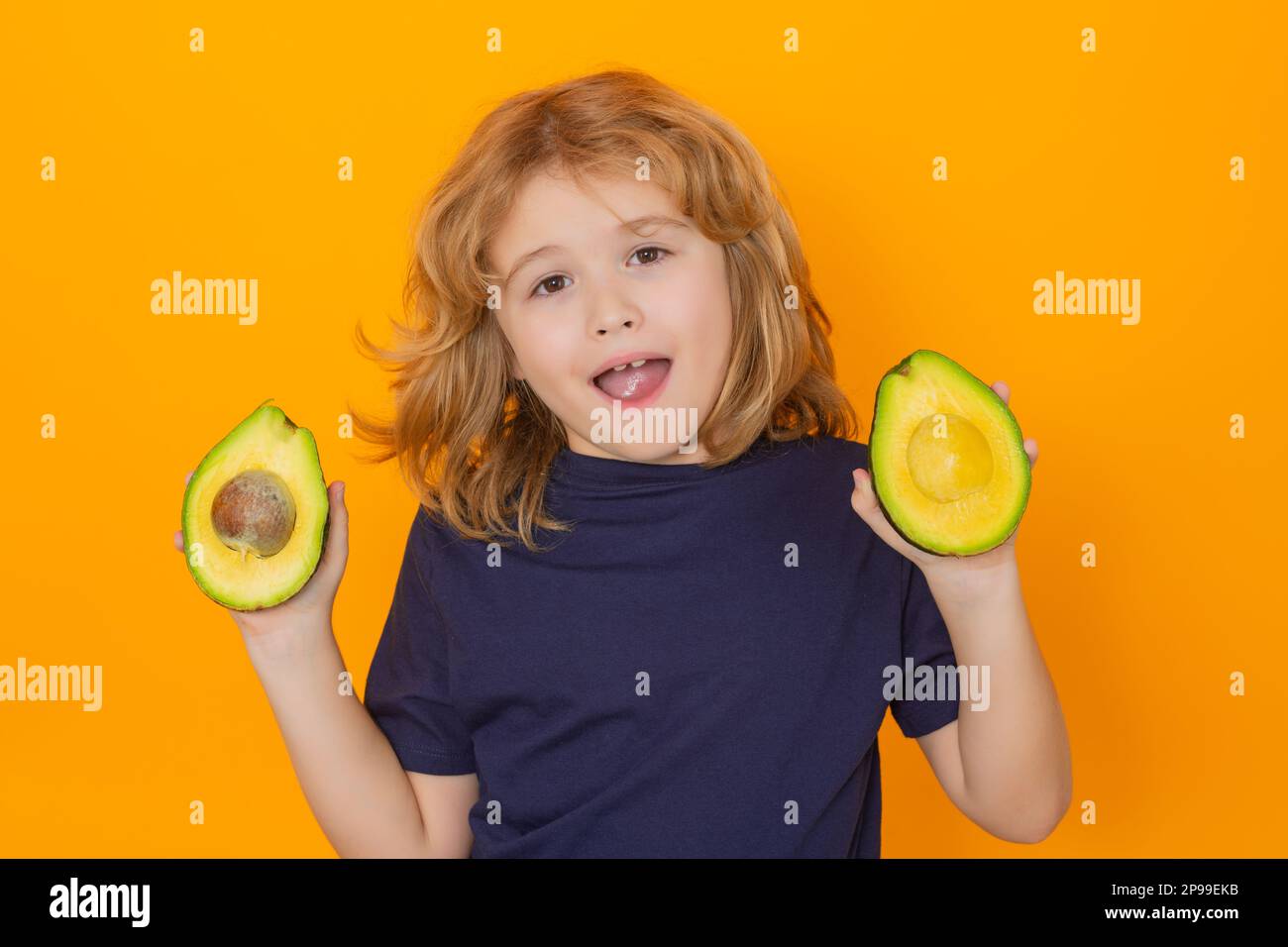 Kid hold red avocado in studio. Studio portrait of cute child with ...