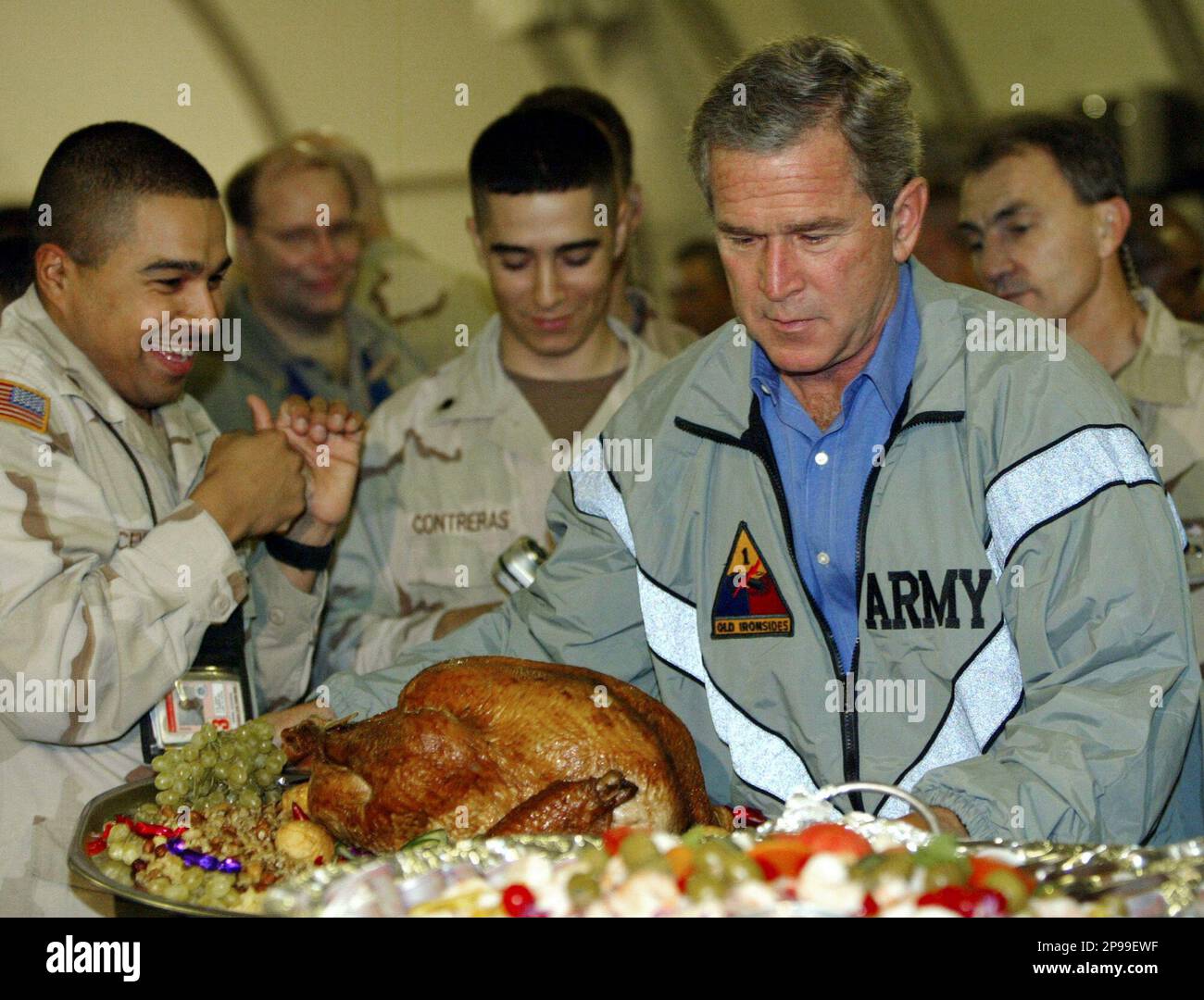 ** FILE ** In this Nov. 27, 2003 file photo, President Bush holds up a ...