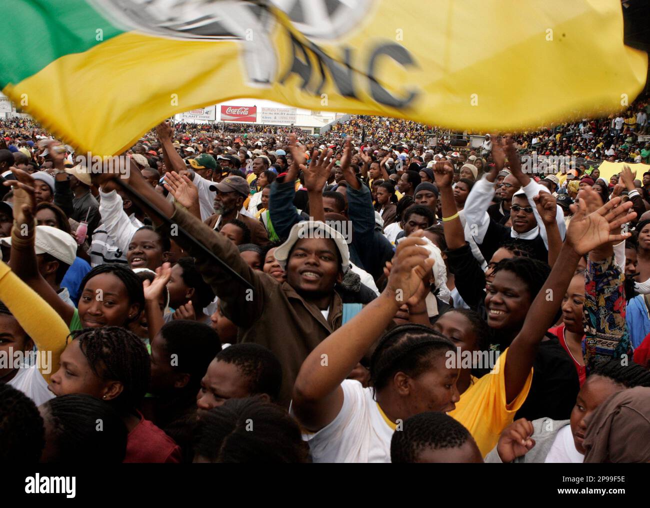African National Congress supporters sing and wave ANC flags during the ...