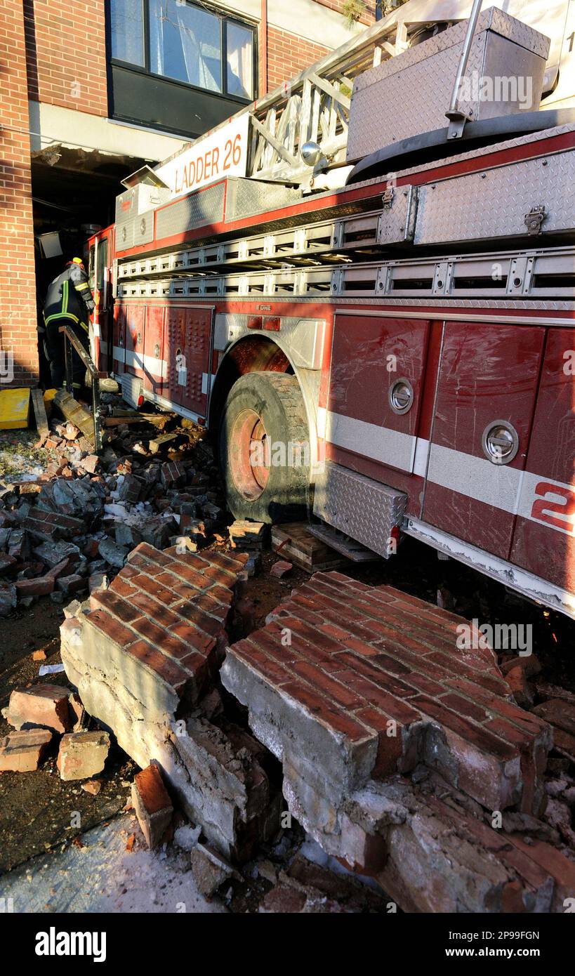 Boston firefighters work to remove a firefighter from a ladder truck ...