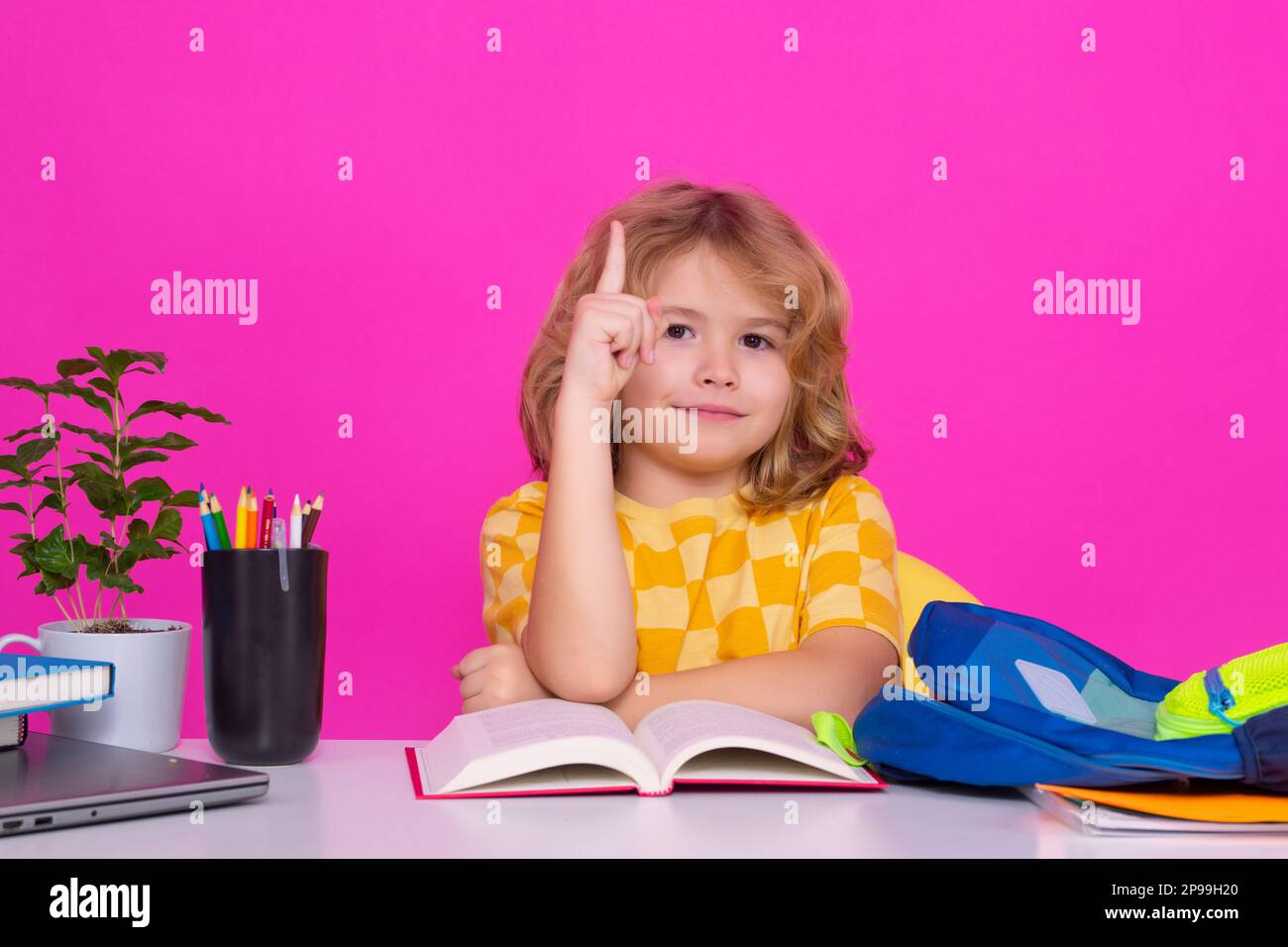 School kid holding index finger up with great new idea. Kid boy from ...
