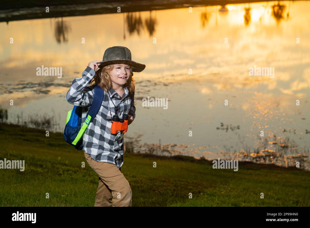 Kid with binoculars hiking at nature. Little explorer. Outdoor ...