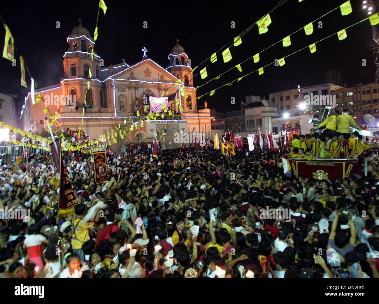 The cart carrying the statue of the Black Nazarene right, inch its way ...
