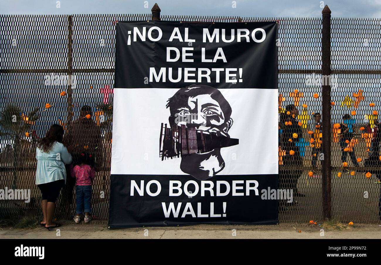 A sign hung by the Raza Rights Coalition hangs on the Mexican side of ...