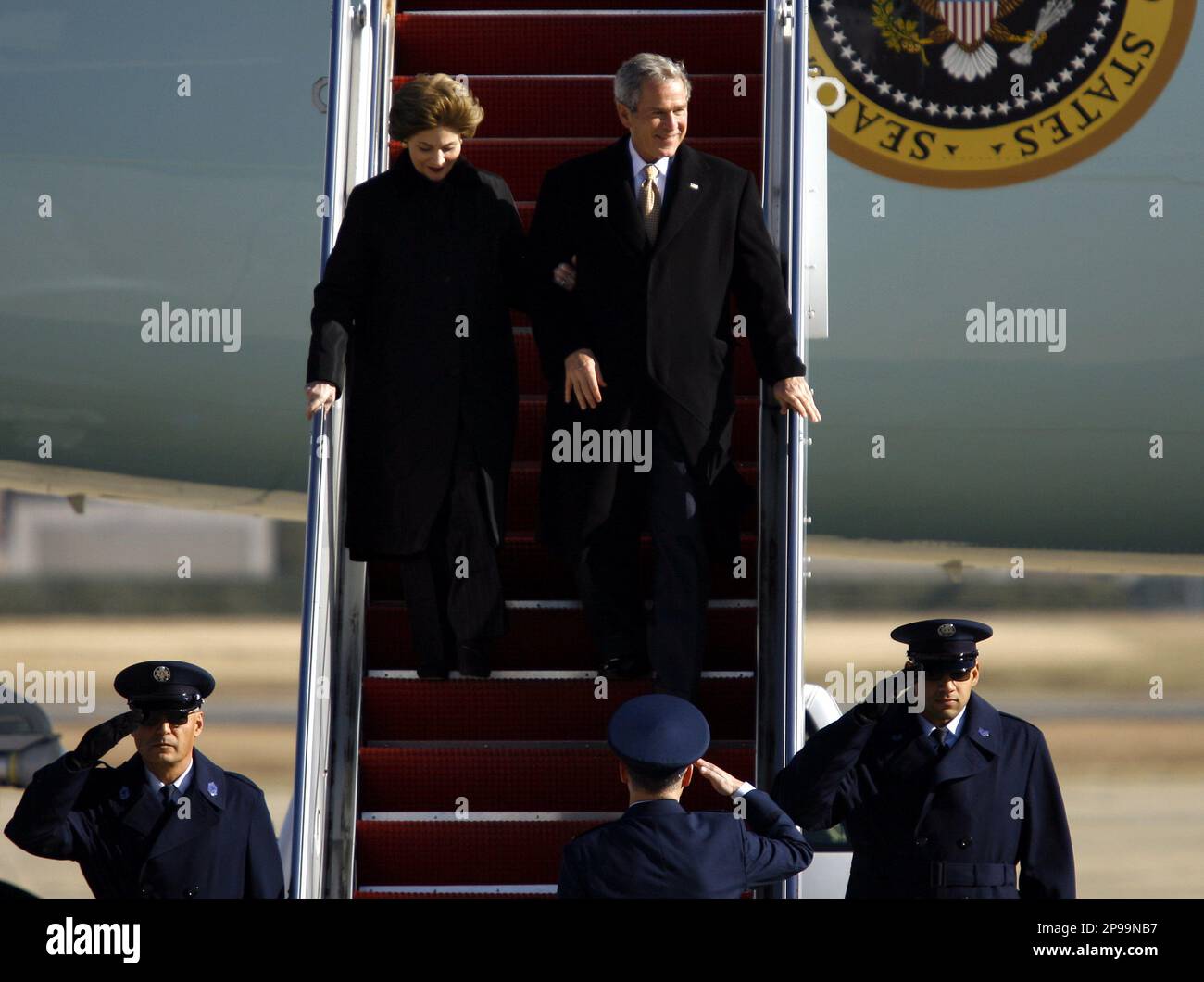 President George W. Bush, and first lady Laura Bush, walk down the ...