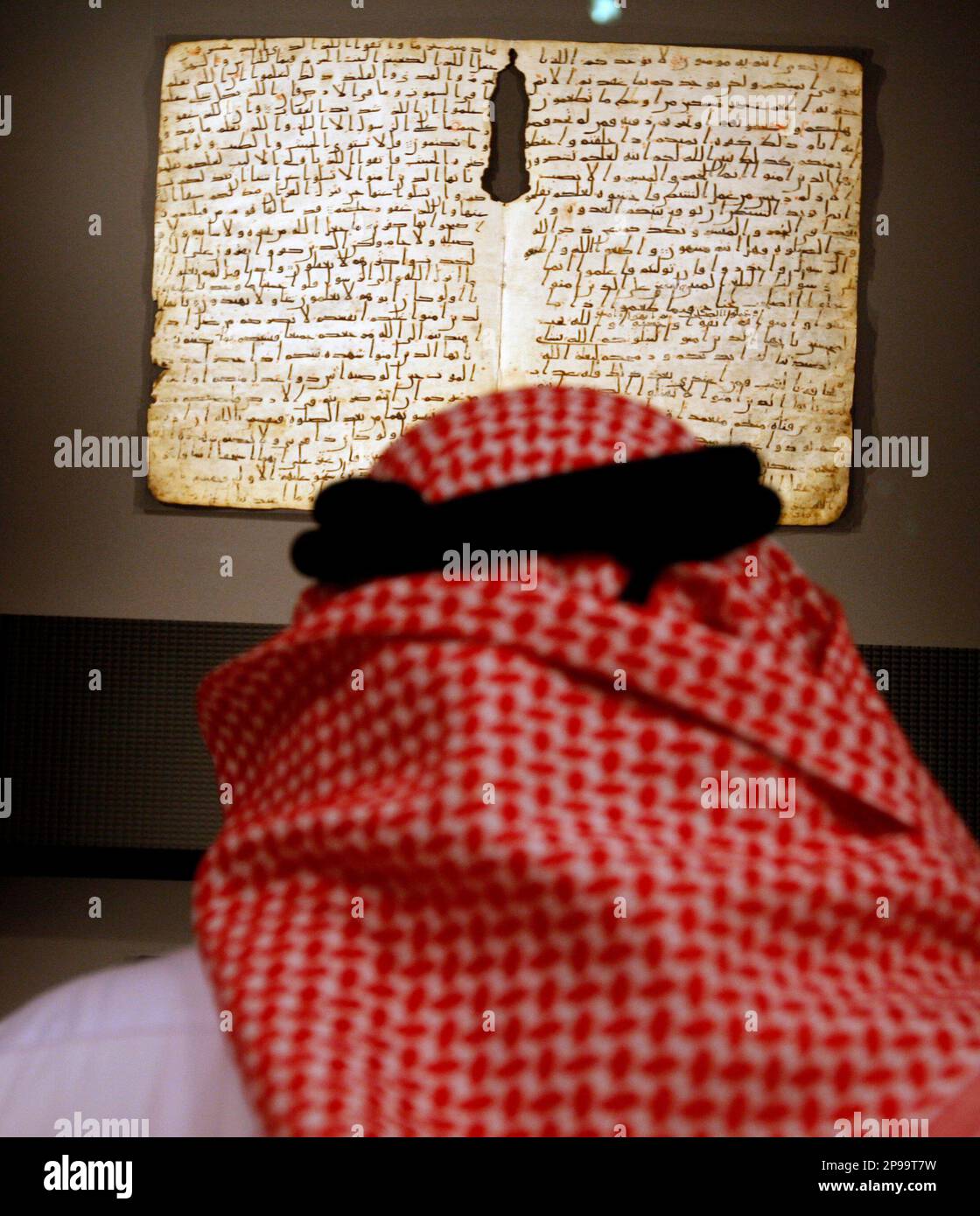 ** FILE ** In this Dec. 1, 2008 file photo a Qatari looks at pages from ...
