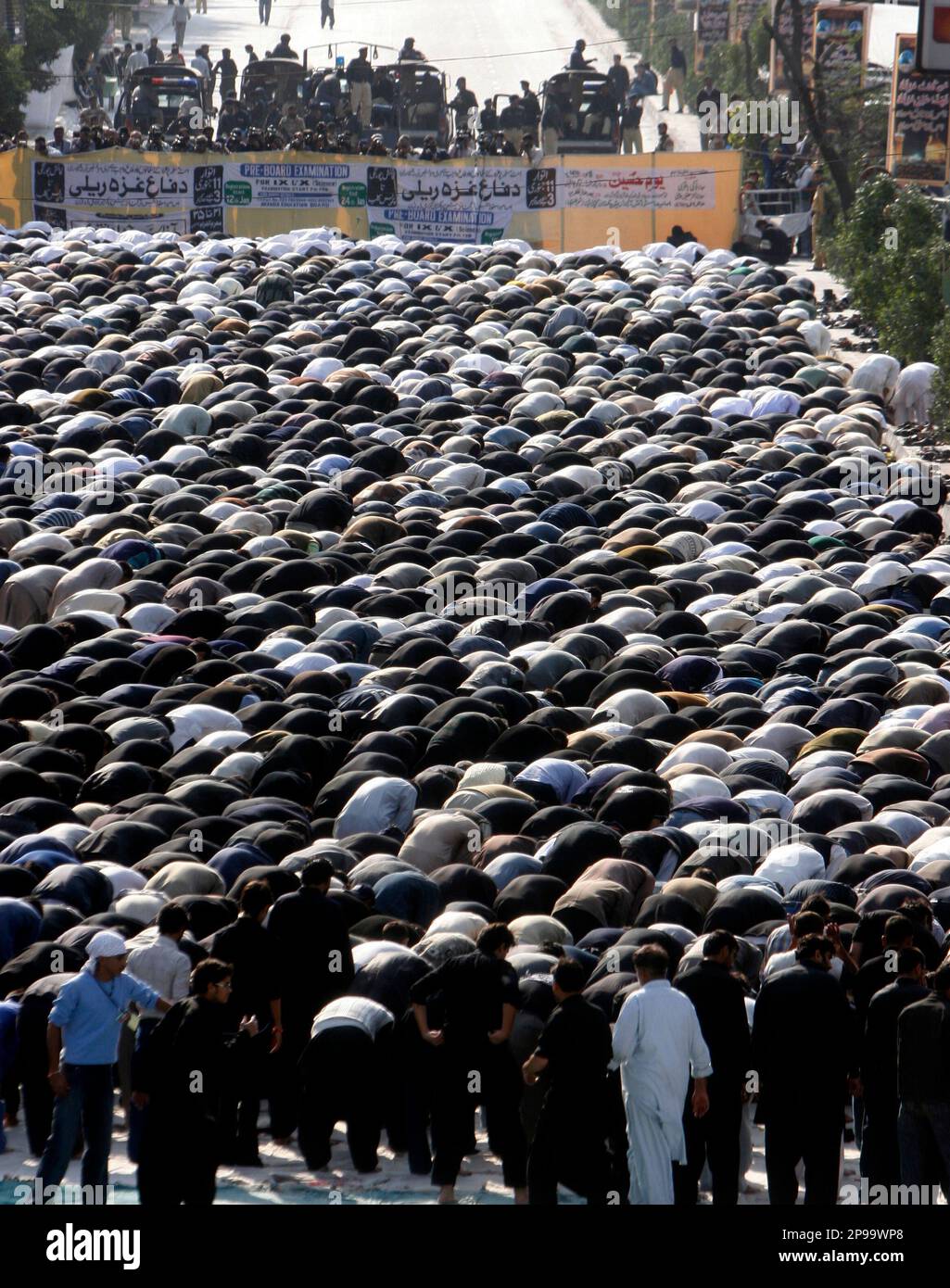 Pakistani Shiite Muslims offer prayers during a procession to mourn the ...