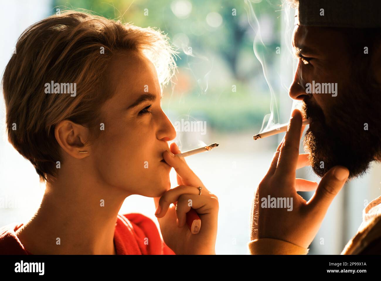 Couple find place for smoking cigarette in tranquility. Enjoying every ...