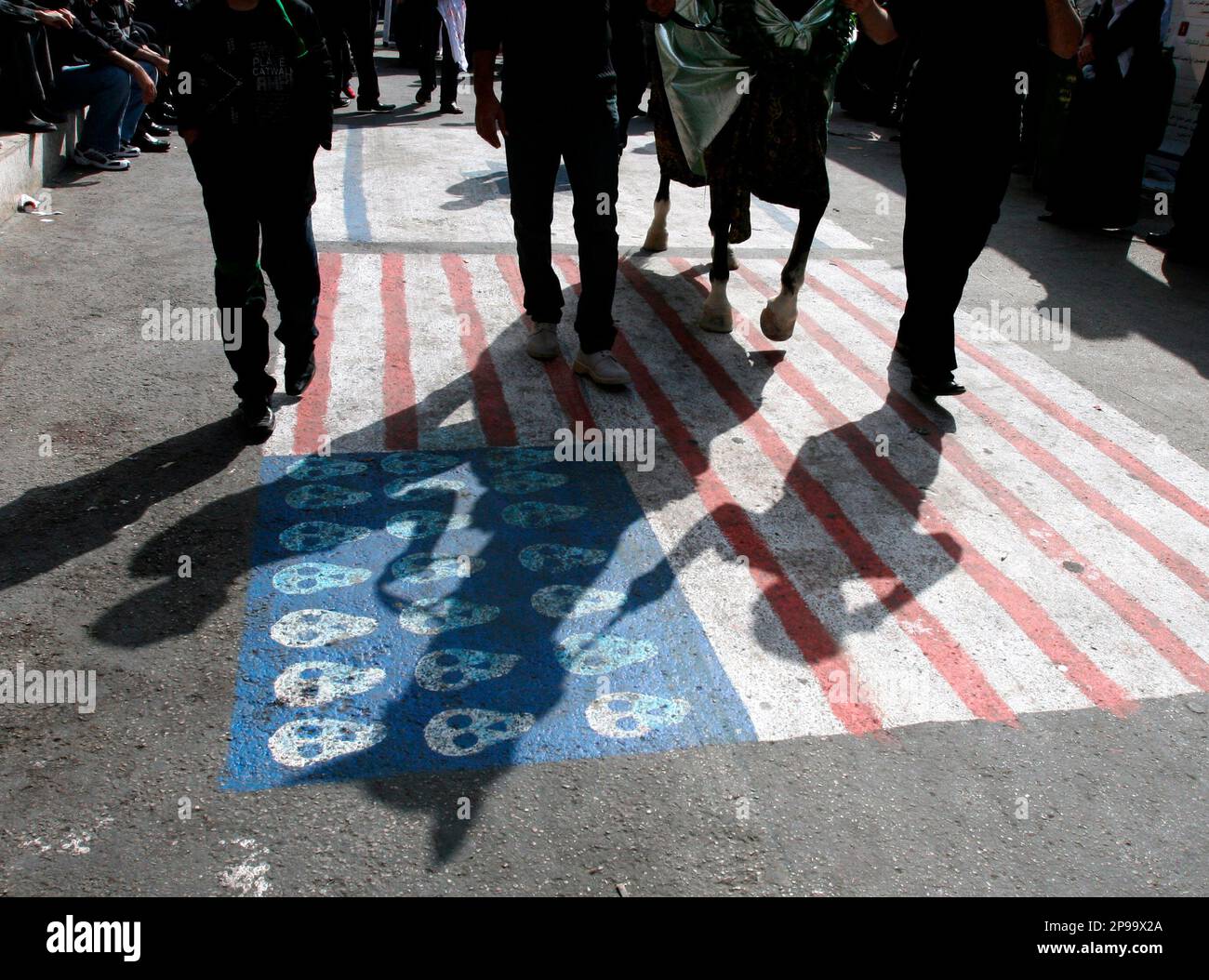 Bahraini men rhythmically beating their chests in mourning lead a horse ...