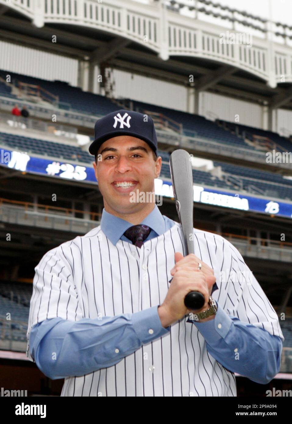 New York Yankees new first baseman Mark Teixeira poses with a bat ...