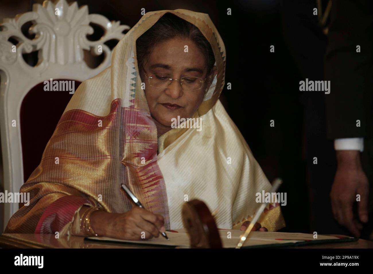 Sheikh Hasina signs the oath document after swearing in as Bangladesh ...