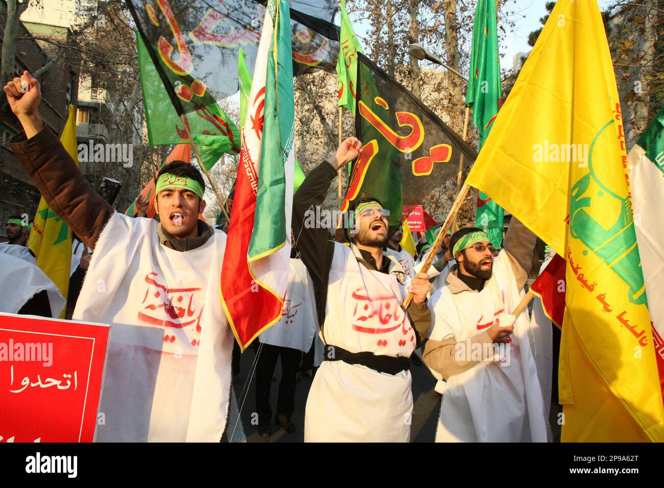 Iranian protestors chant slogans as they wear white shrouds to indicate ...