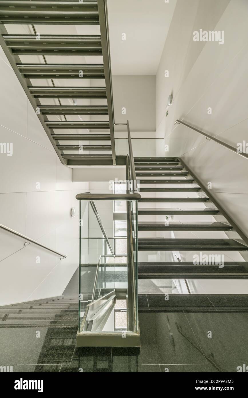 Metal stairs of an office building with polished black granite steps ...