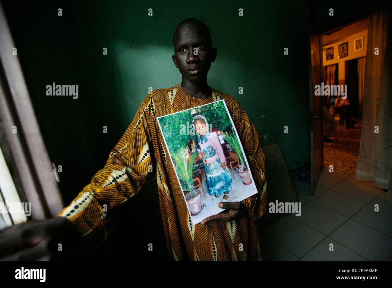 Demba Diaw, a 31-year-old teacher, holds a picture of his 4-year-old ...