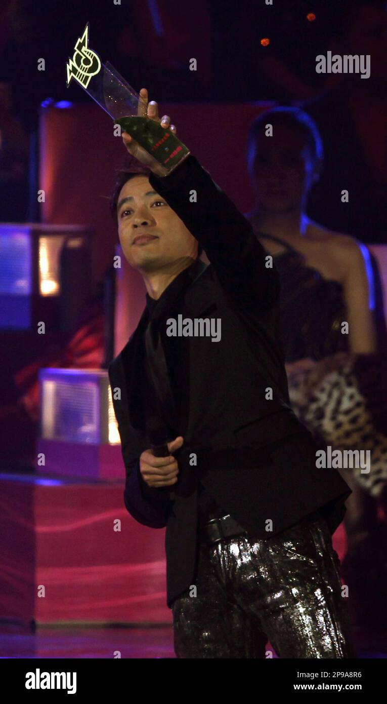 Hong Kong singer Hacken Lee, holding his trophy, performs after winning ...