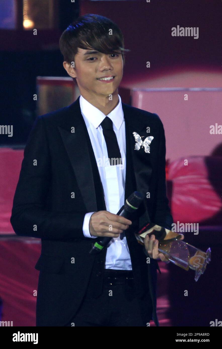 Mainland China singer Hins Cheung, holding his trophy, performs after ...