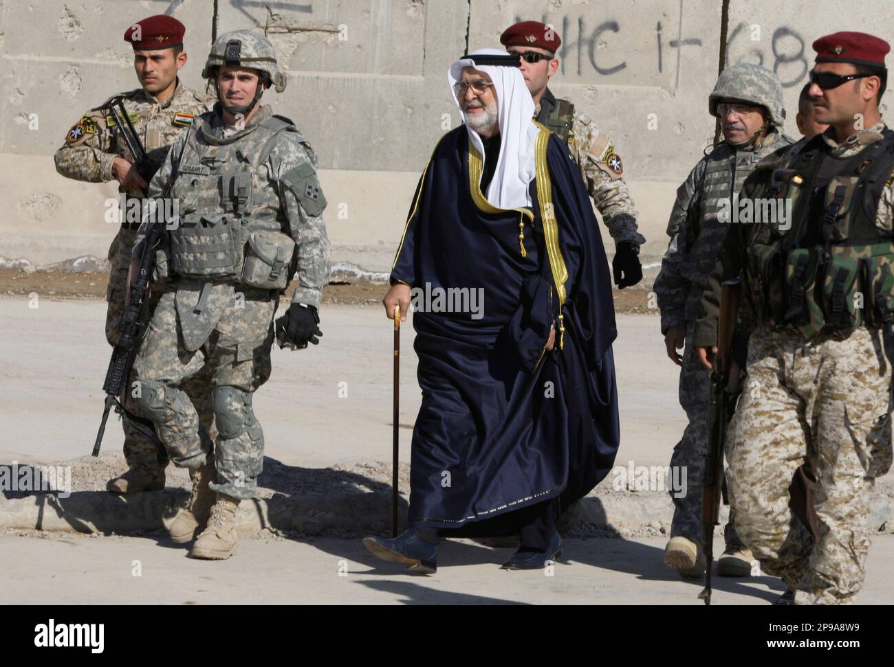 U.S. and Iraqi soldiers walk with the Azamiyah Awakening council leader ...