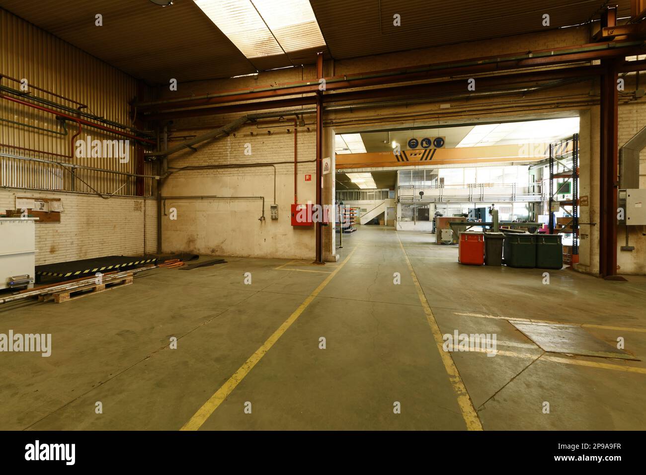 Warehouse of a factory with large-tonnage cranes on rails on the roof ...